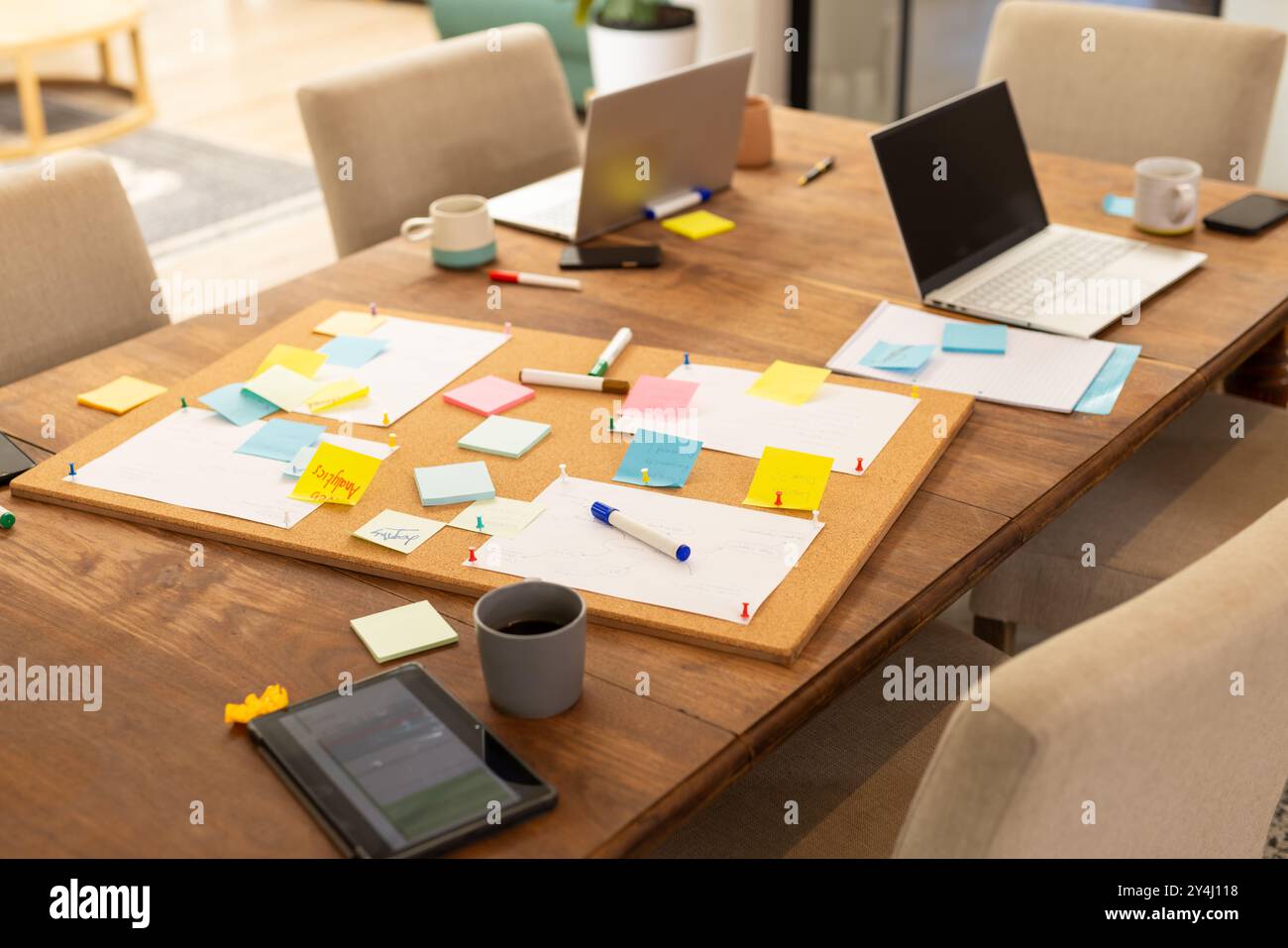 Brainstorming ideas, friends using laptops and sticky notes on wooden ...