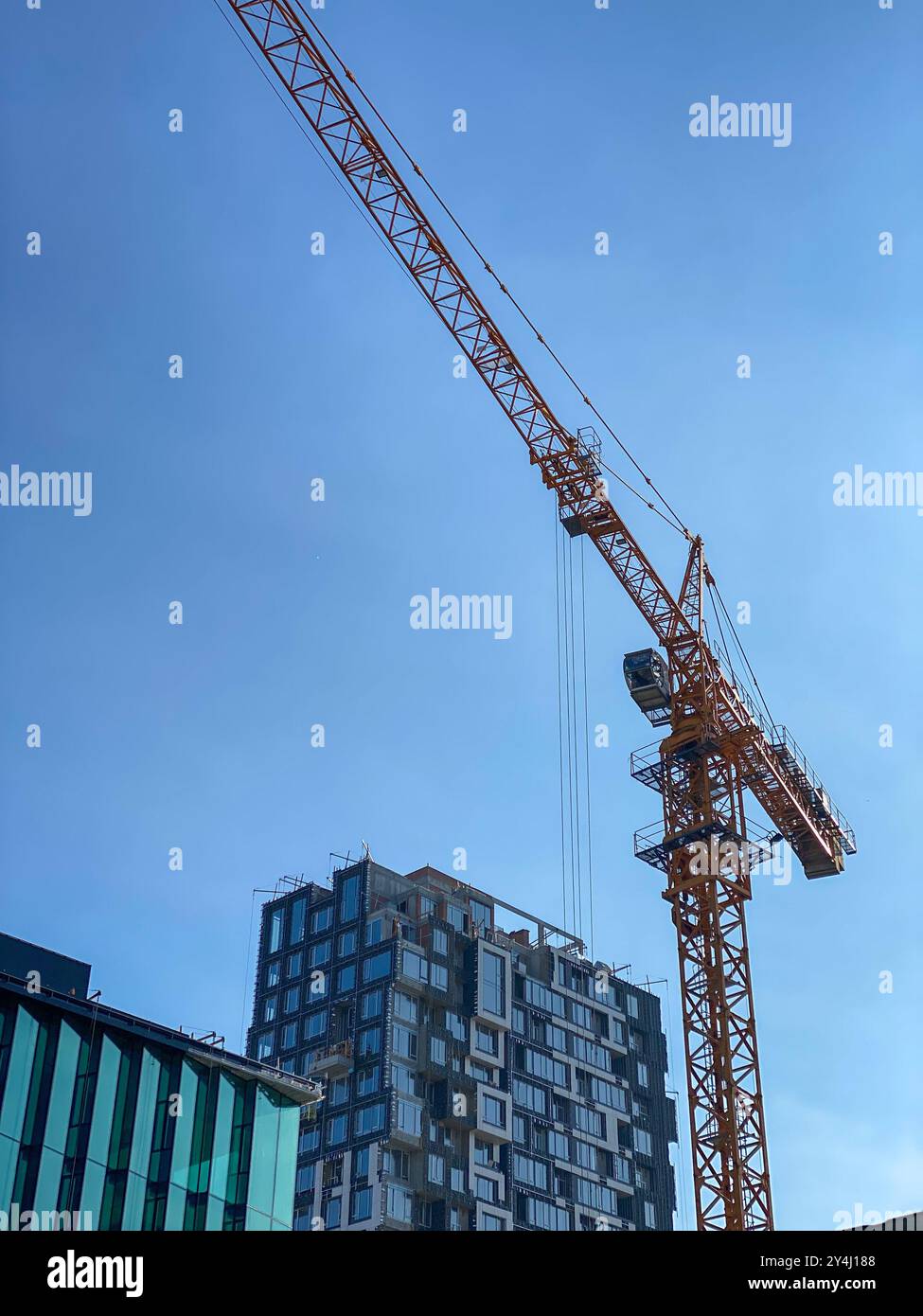 Building around crane construction equipment Stock Photo - Alamy