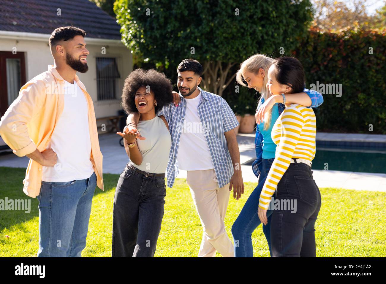 Laughing and chatting, group of young friends enjoying time together ...