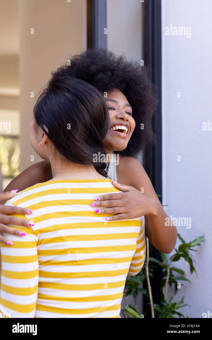 Hugging and smiling, two friends enjoying happy reunion Stock Photo - Alamy