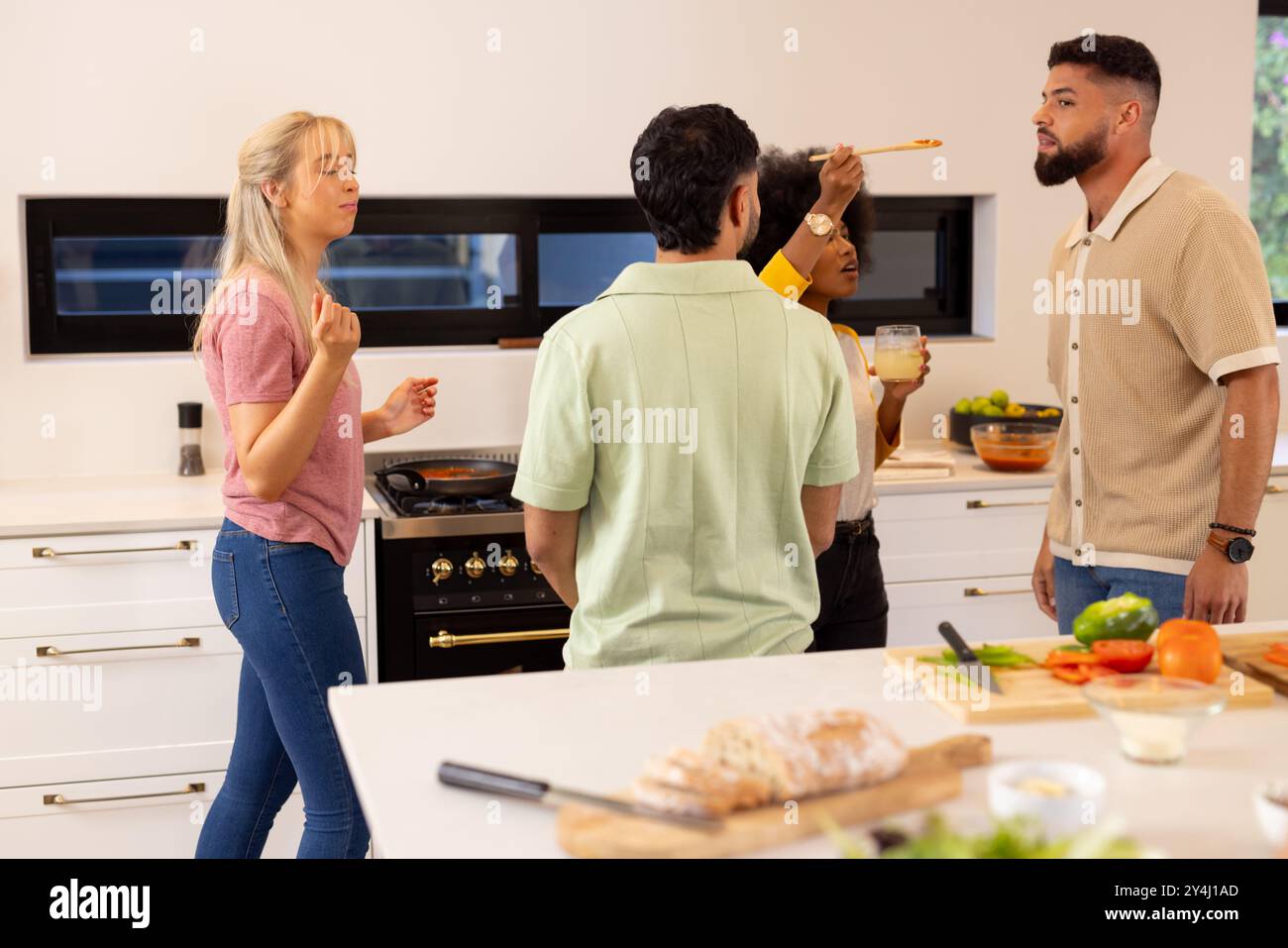 Cooking together, group of diverse friends enjoying food and ...