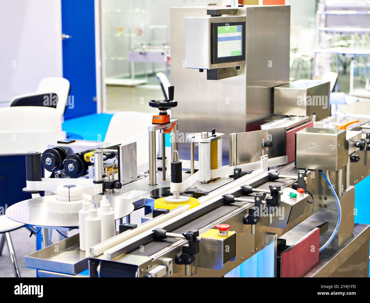 Industrial plastic bottle labeling machines Stock Photo - Alamy