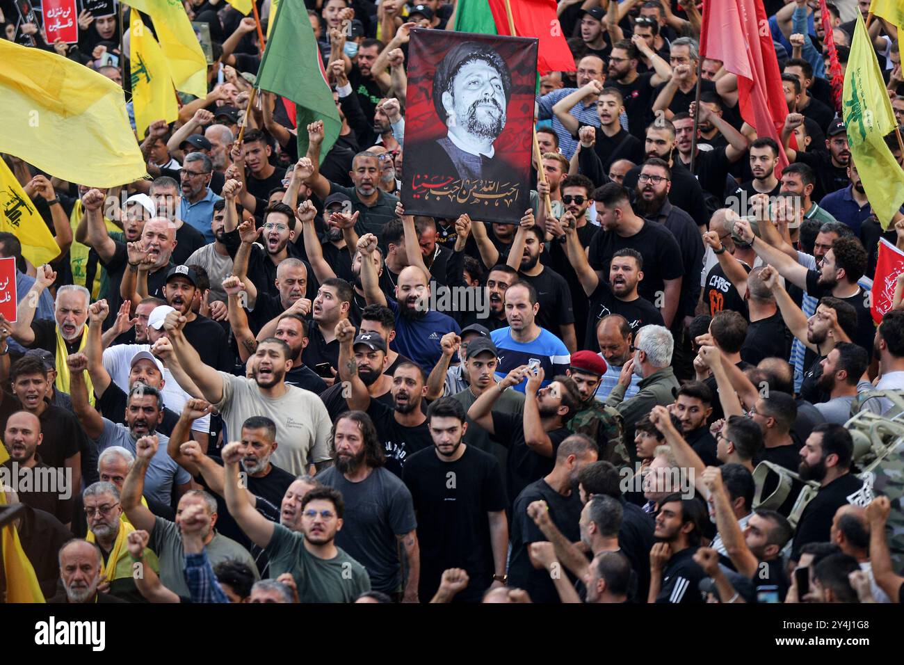 18 September 2024, Lebanon, Beirut: Hezbollah supporters raise their ...