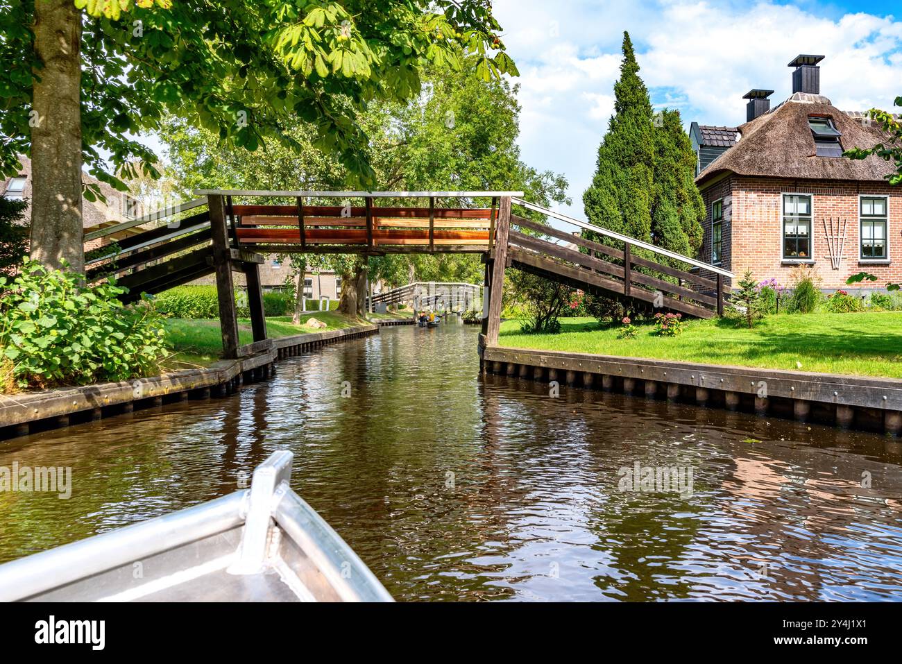 Traditional Dutch thatched-roof cottages on the canal in the village of ...