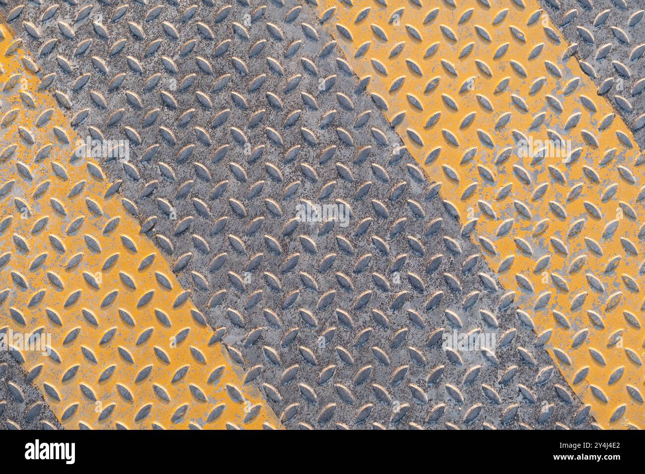 A scratched, corrugated metal ramp on the road features yellow painted ...