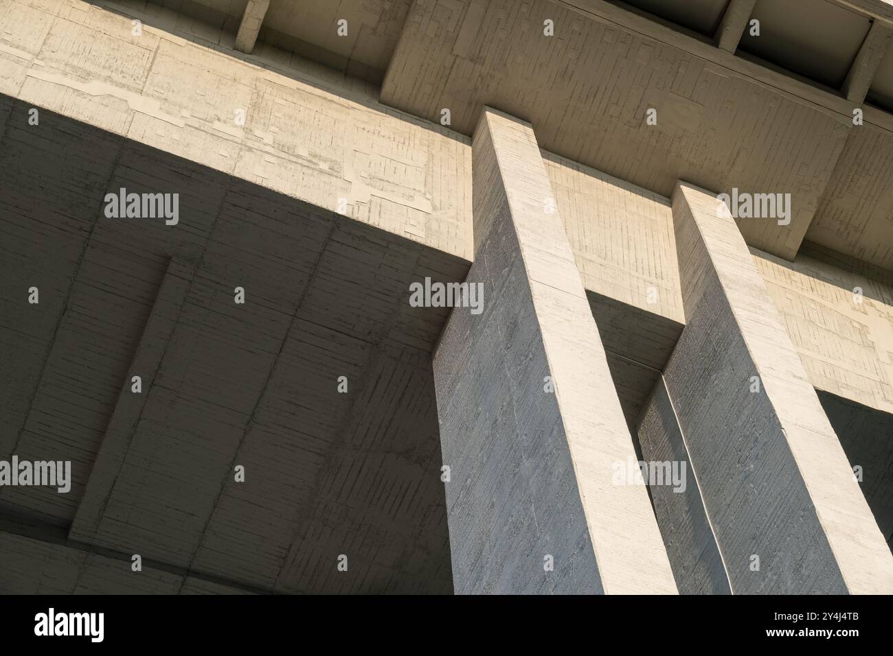 Abstract concrete columns supporting a bridge, viewed from below ...