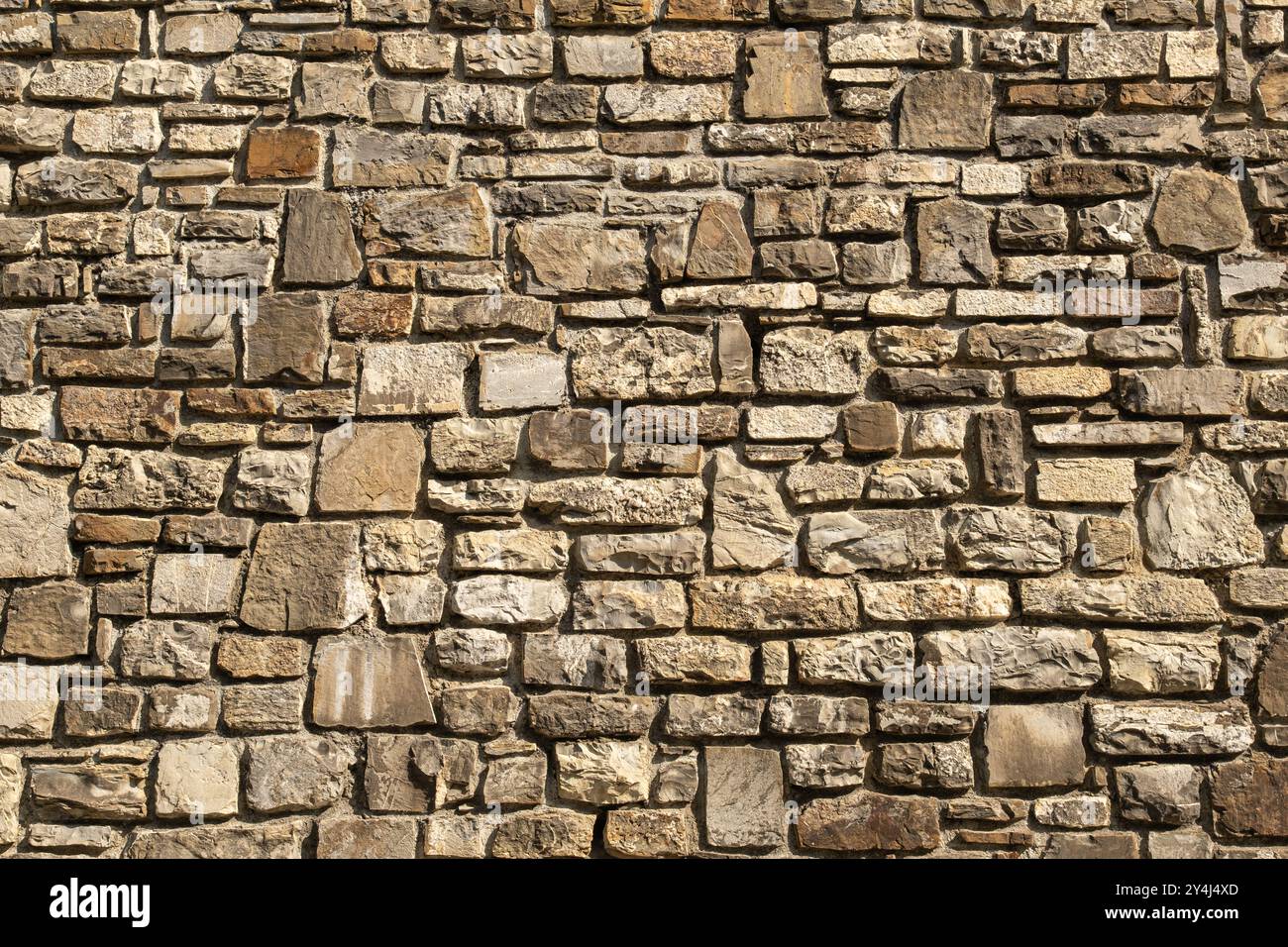 stone wall made of limestone, typical of ancient cities. The ...