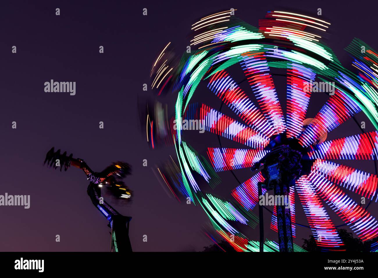 Light trails from the 'Star Flier' fairground ride at the annual ...