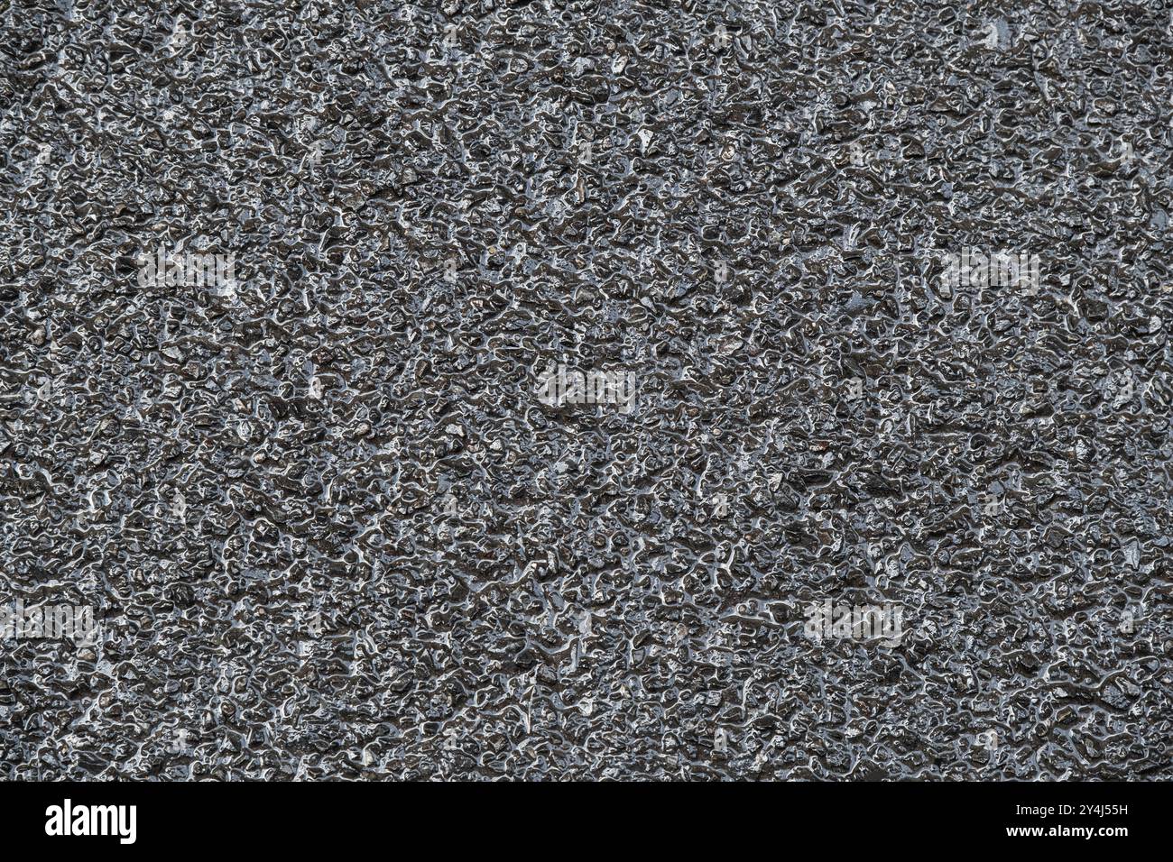 New wet asphalt texture. A frame filled with the textured surface of ...
