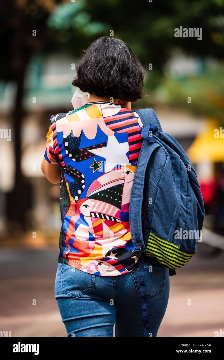 Back view of Brazilian woman wearing a shirt with colorful pattern ...
