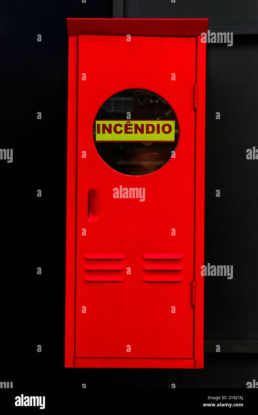 Brazilian fire extinguisher box painted bright red with a door with a ...