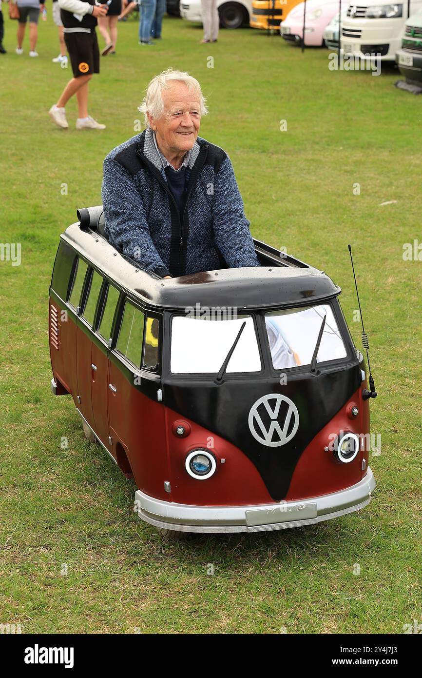 Novelty VW campervan vehicle with smiley pensioner Stock Photo - Alamy