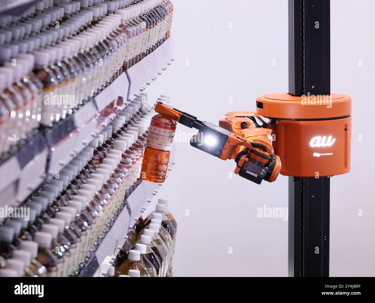 Tokyo, Japan. 18th Sep, 2024. A robot picks a bottle from a rack for a ...