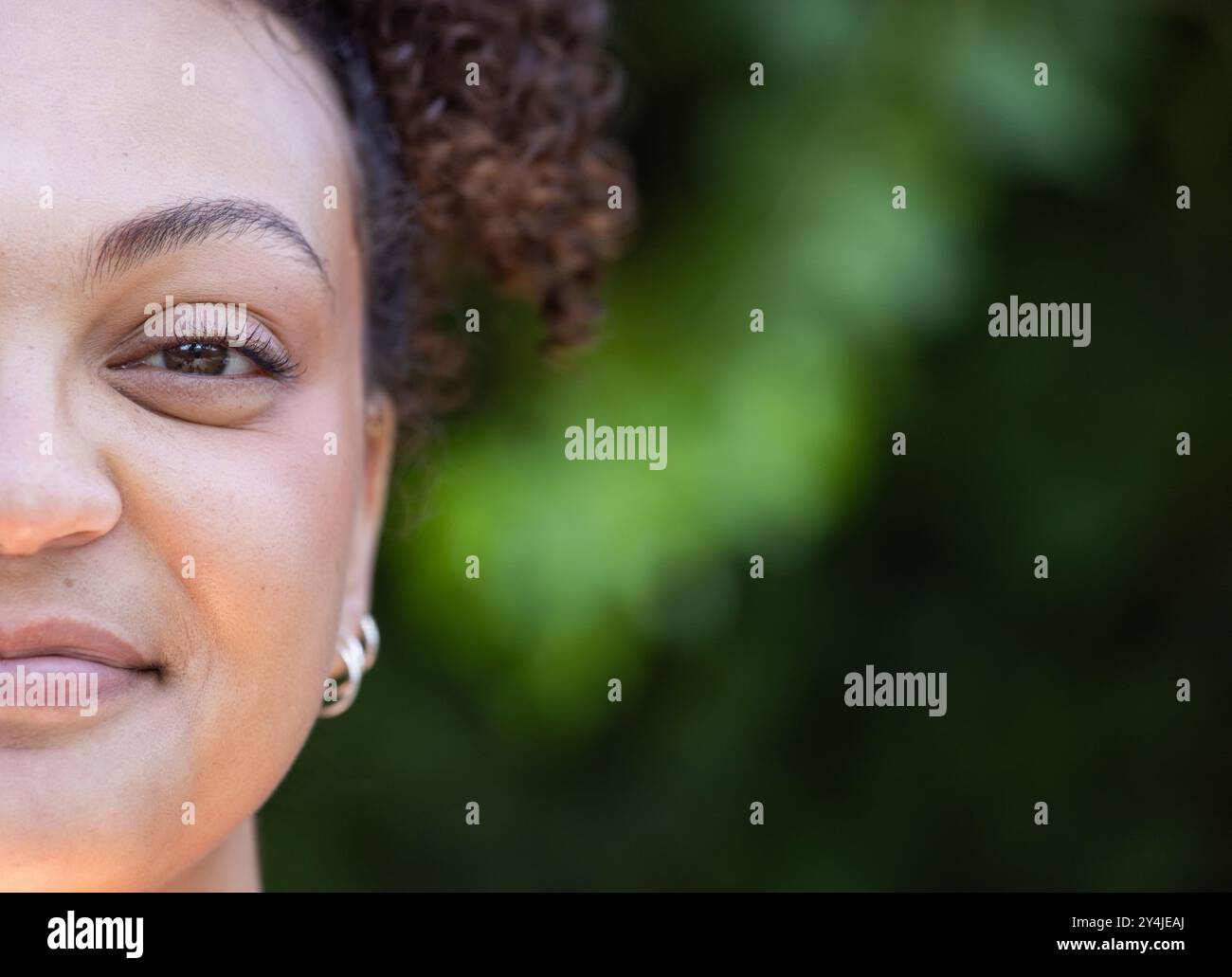 Smiling woman with curly hair with curly hair outdoor, close-up ...