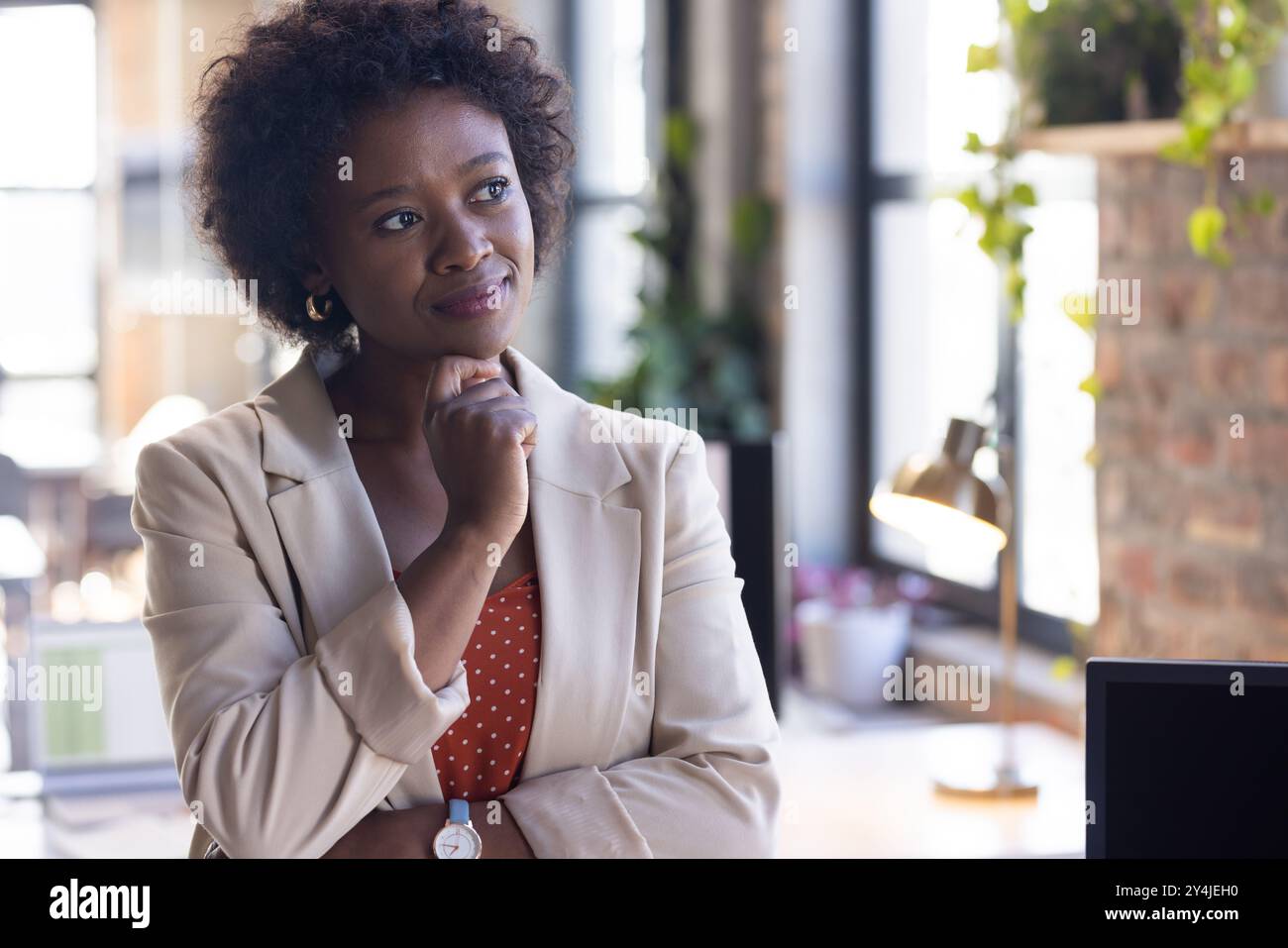Thinking deeply, businesswoman in office wearing blazer and polka dot ...