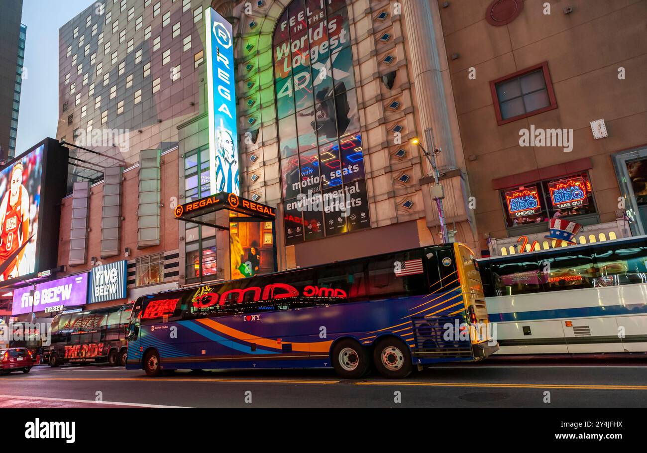 The marquee of the AMC Empire 25 Cinemas is reflected in a bus outside ...