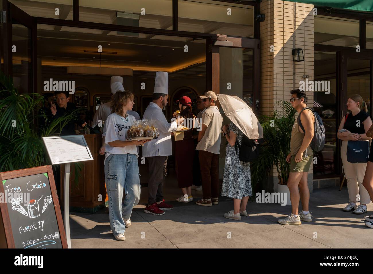 Gelato lovers line up outside of the opening of Realmuto Alta ...