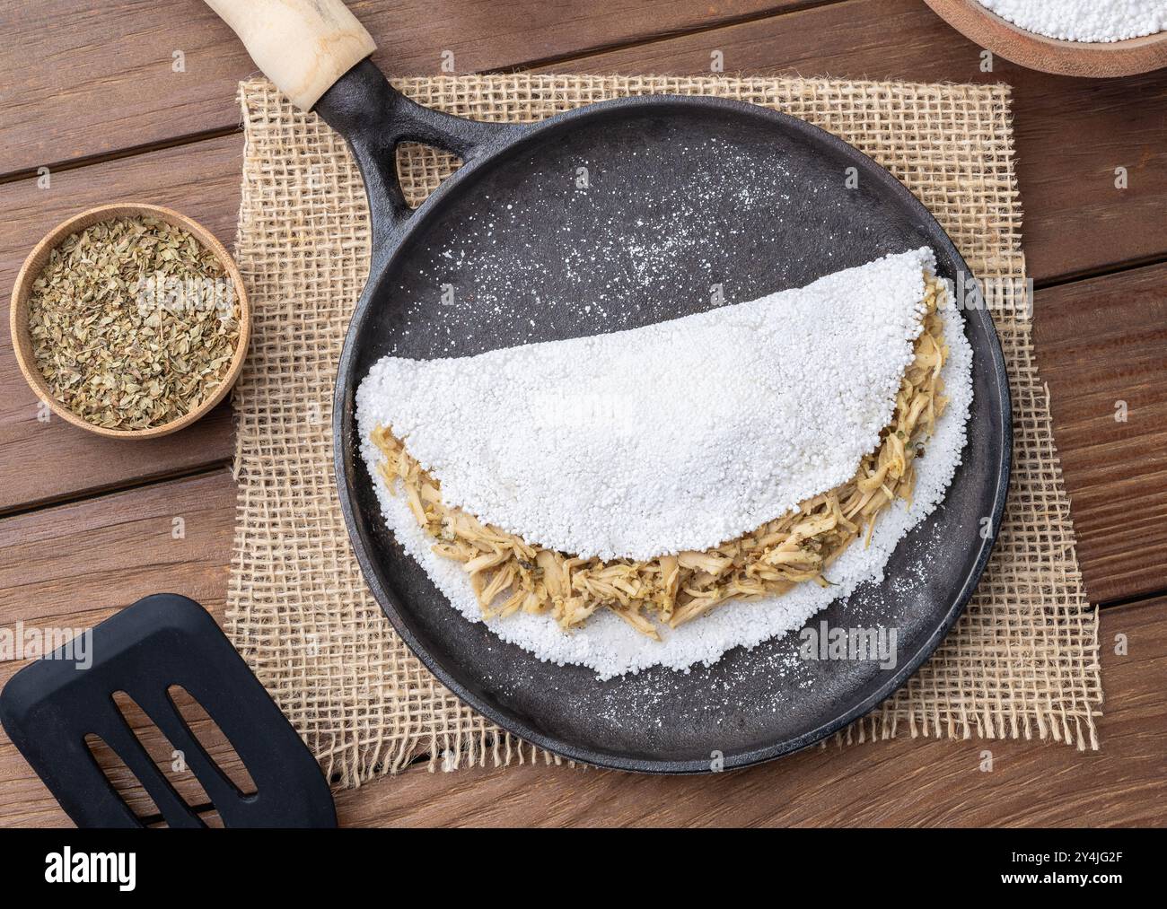 Traditional brazilian chicken stuffed tapioca on a pan with ingredients ...