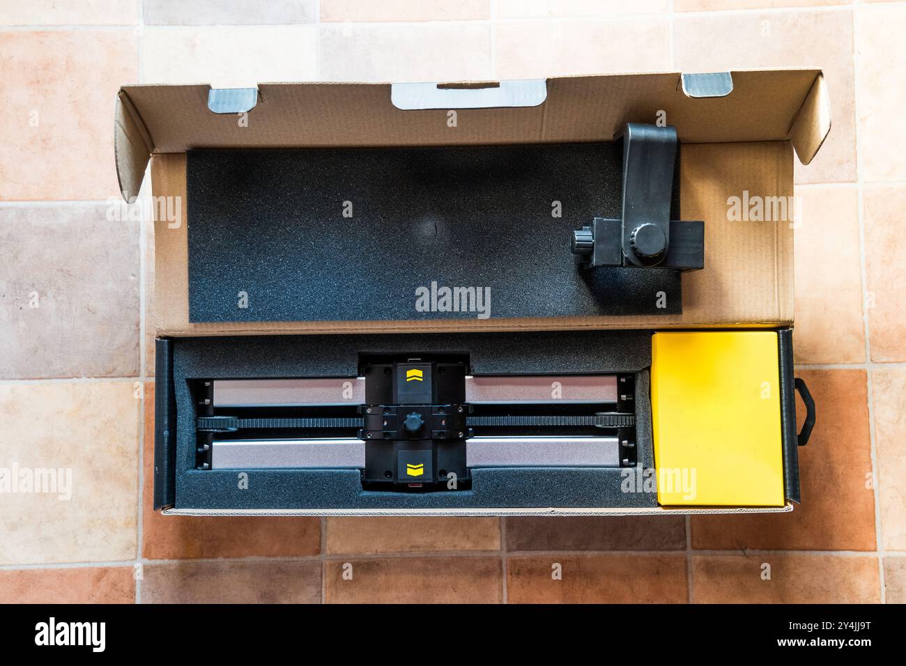 New professional slider for video filming lying in open cardboard box ...