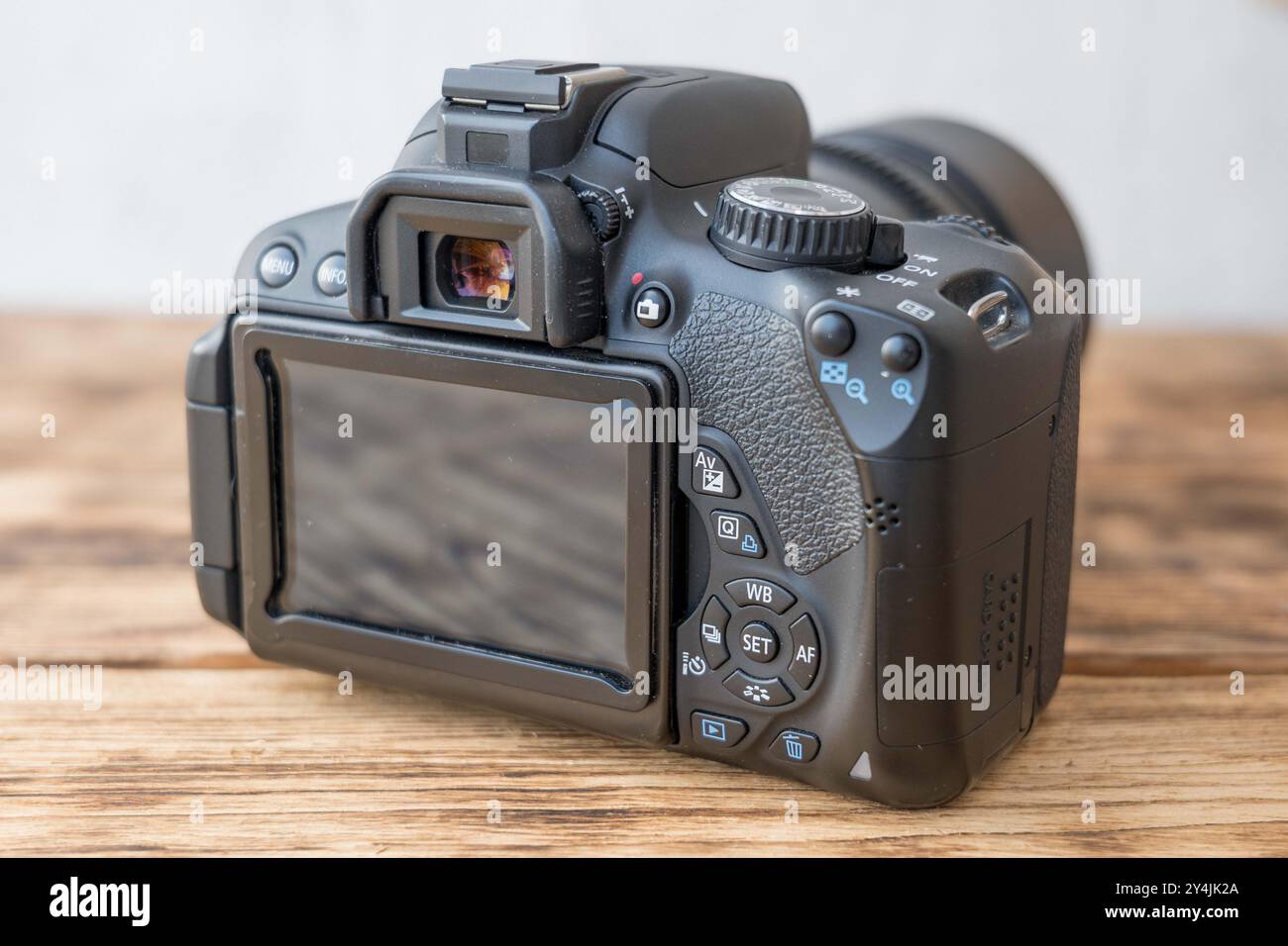 Modern dslr camera sitting on wooden table back side showing Stock ...