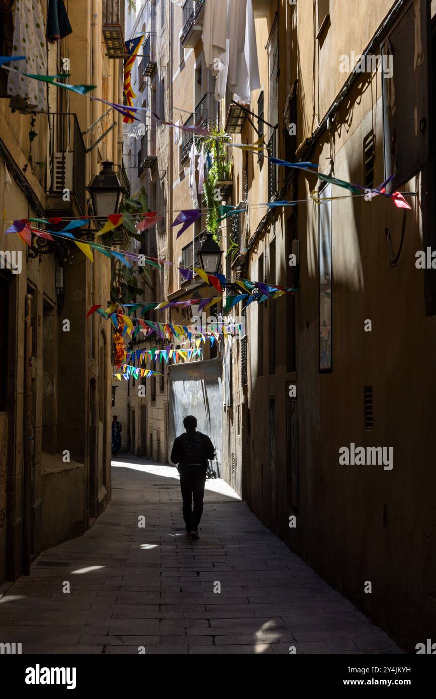 A man walks down a narrow street in the Bari Gothic district in ...