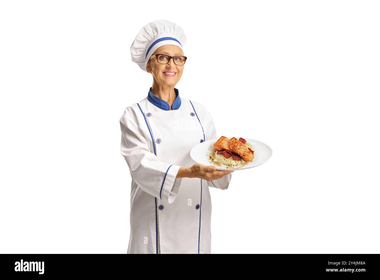 Female chef holding a cooked salmon with rice on a plate, fine dining ...