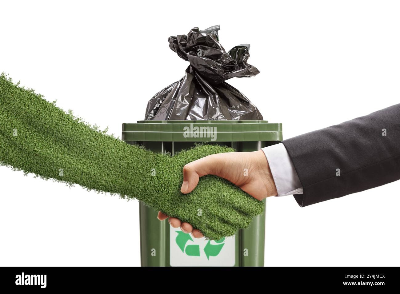Businessman shaking hand with a green grass hand in front of a ...