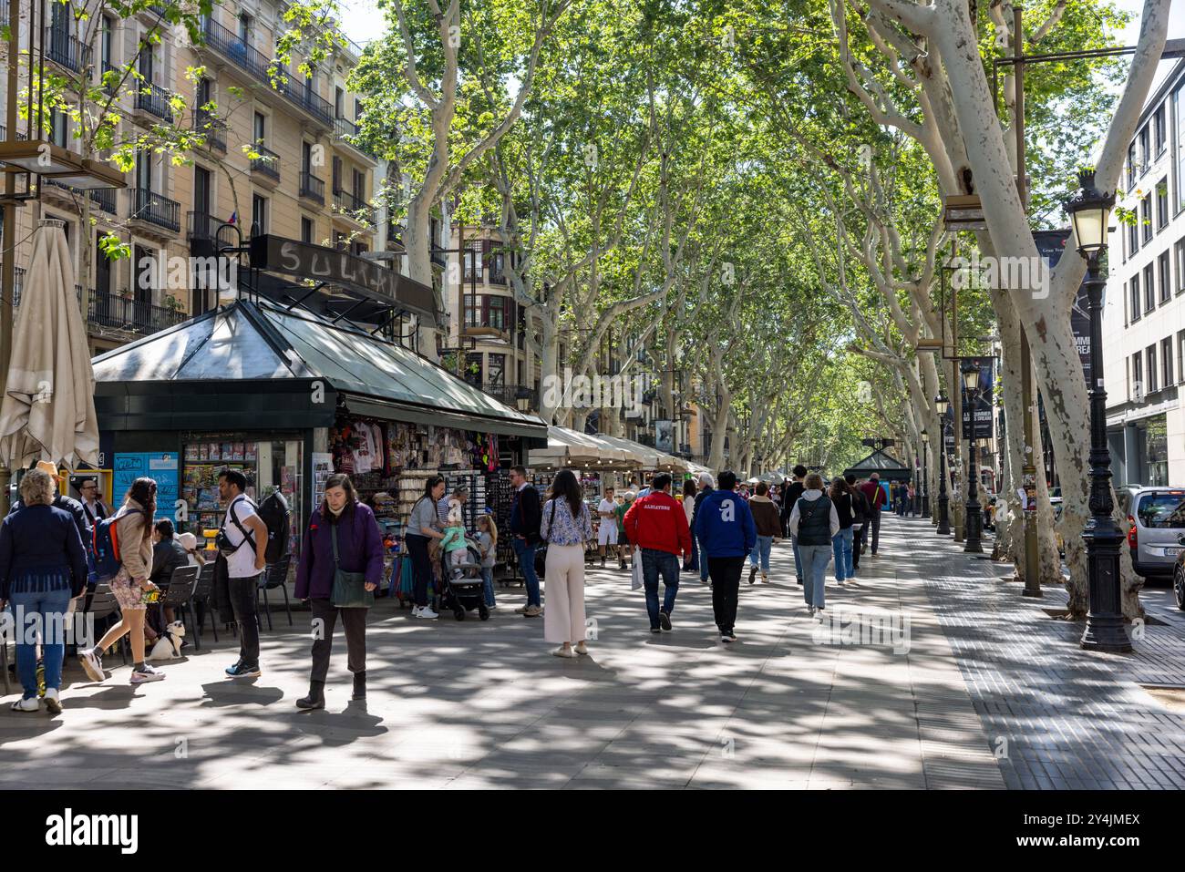 People stroll along La Rambla, one of Barcelona, Spain's most famous ...