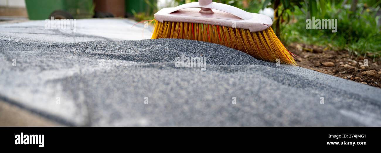 Domestic project of paving an putdoor patio with concrete tiles - broom ...