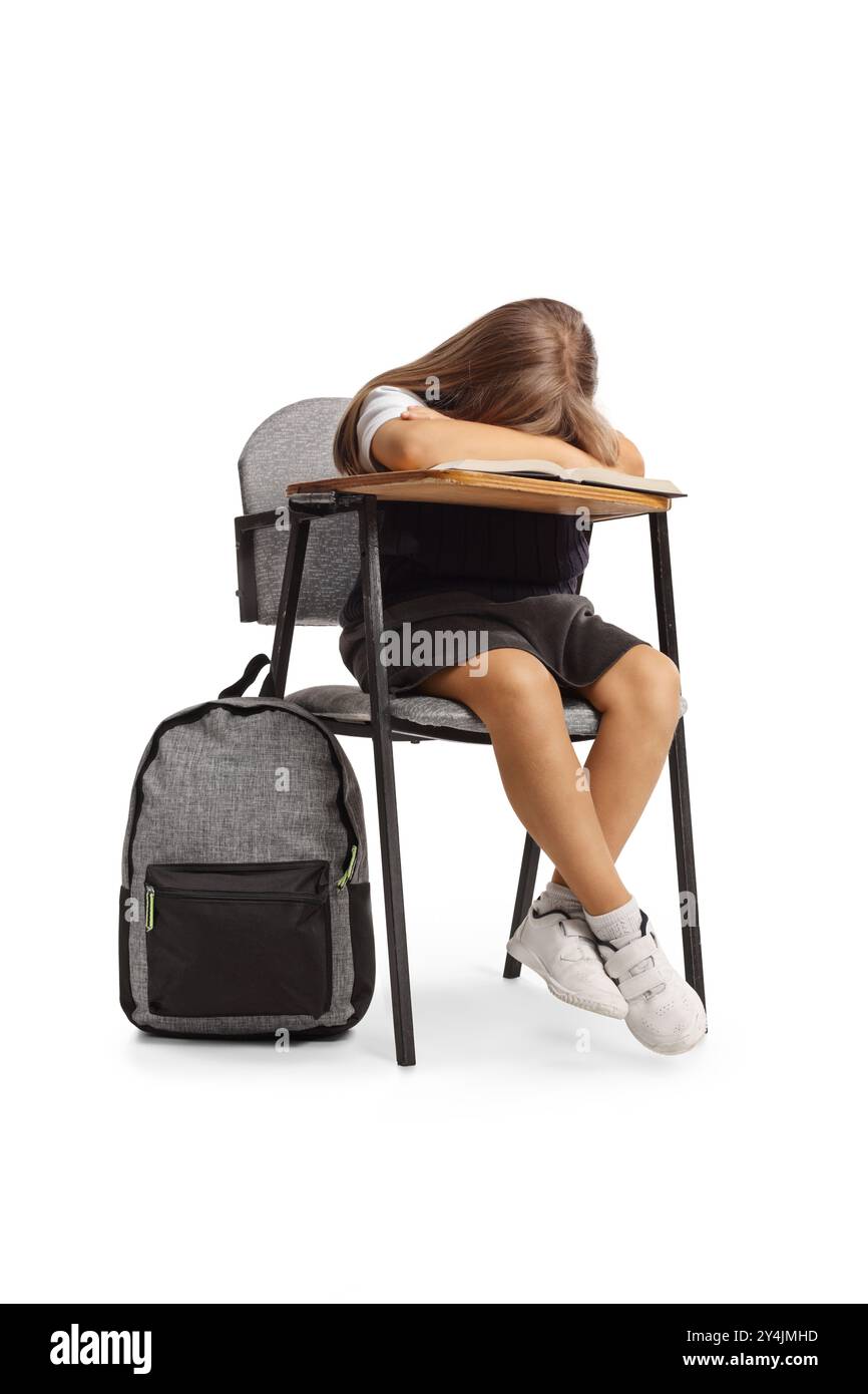 Tired schoolgirl sleeping in a school chair isolated on white ...