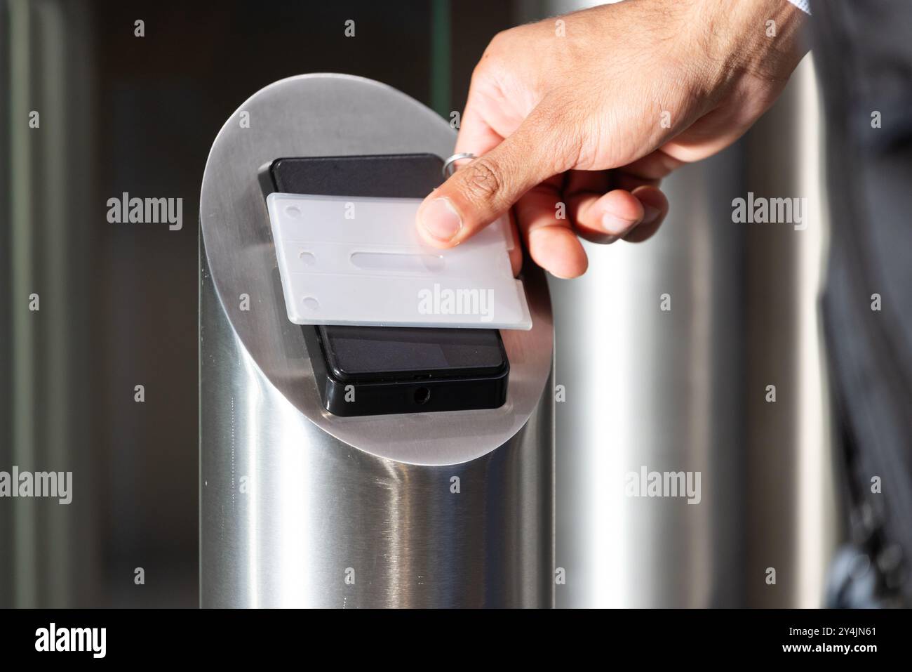 Scanning access card, person entering secure office building for work ...