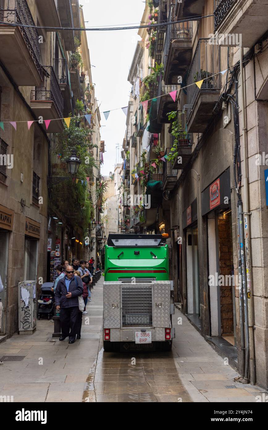 A small street cleaning vehicle cleans the narrow streets in La Ribera ...