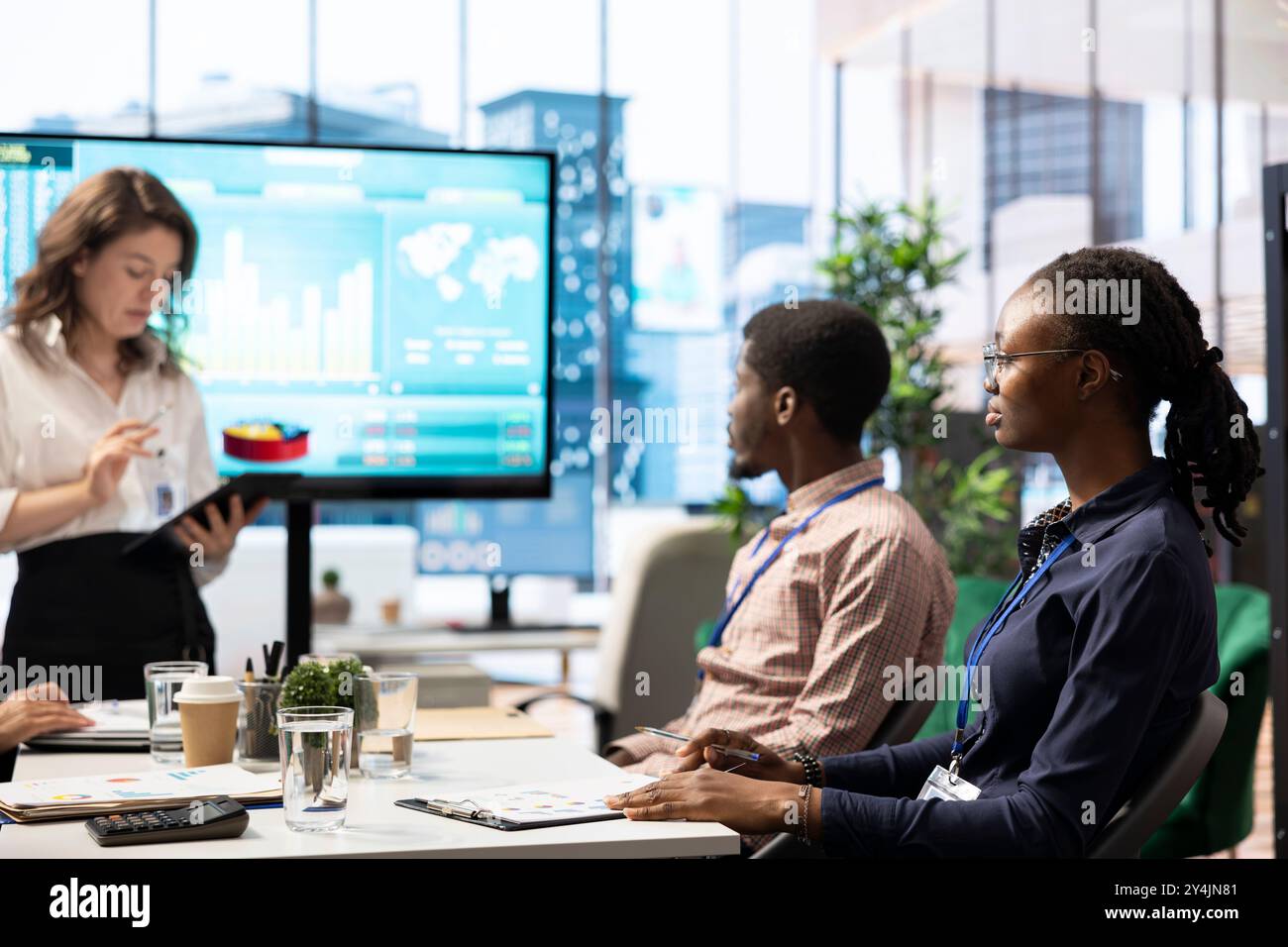 Coworkers engaging in a problem solving meeting at a corporation, using ...