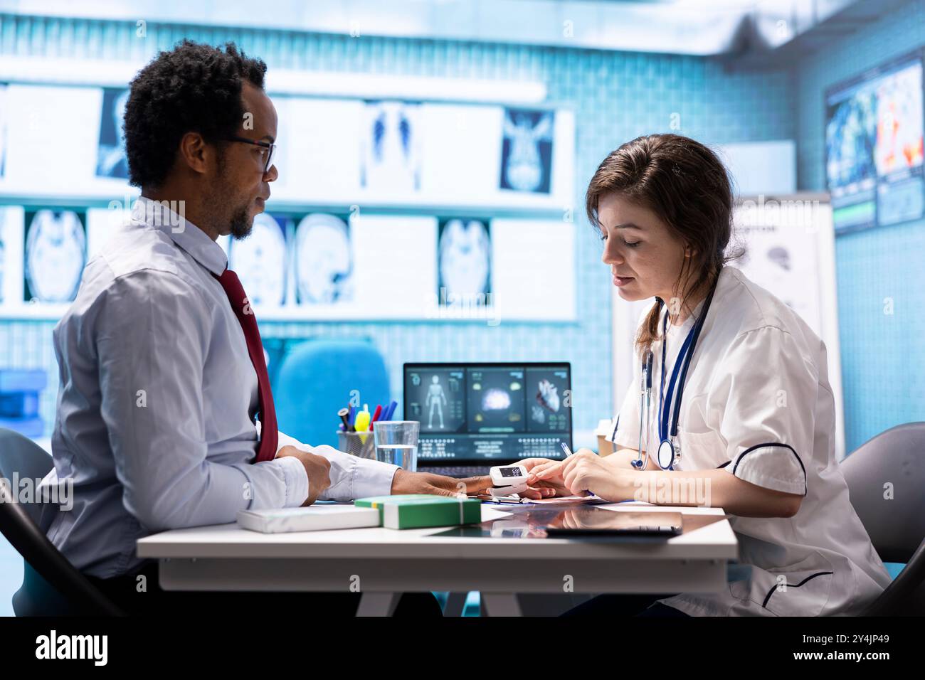 Physician specialist placing an oximeter on patient finger to take ...