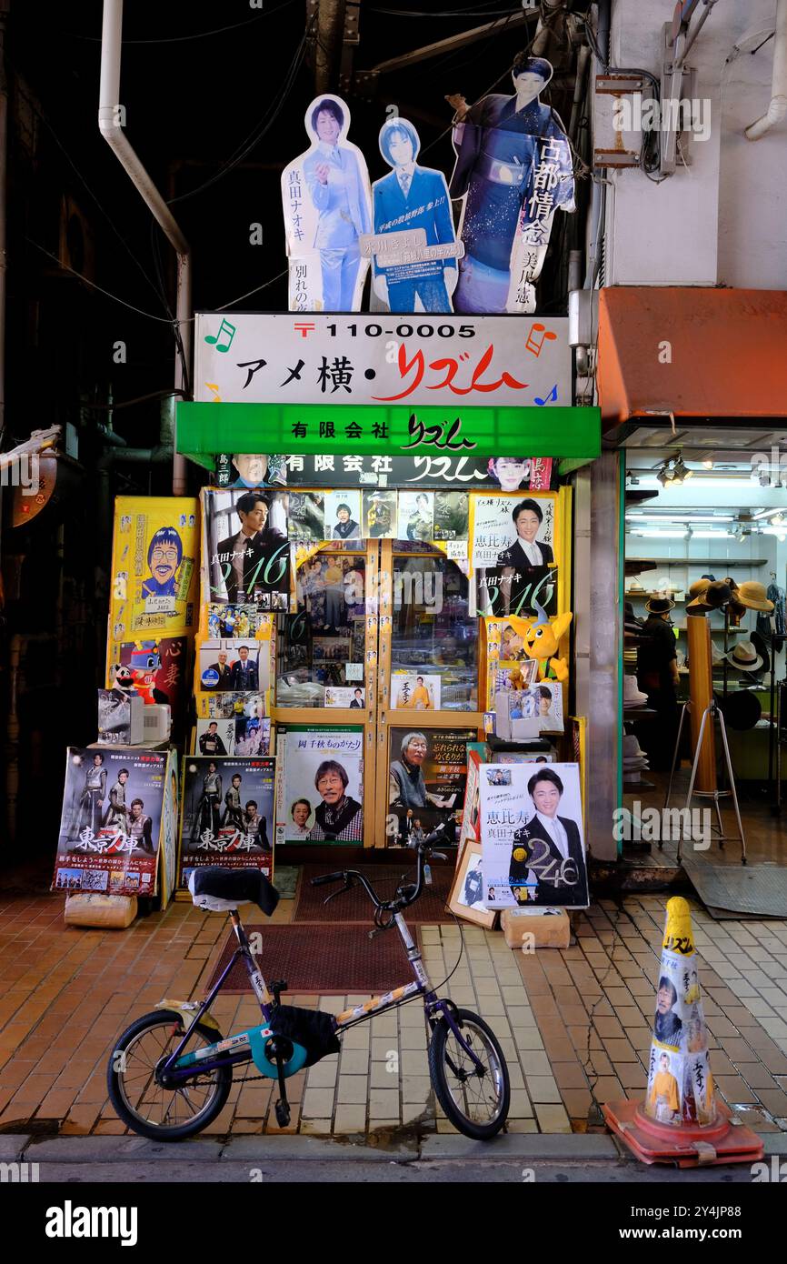 A small music store with posters on a sideway of Ameyoko shopping ...