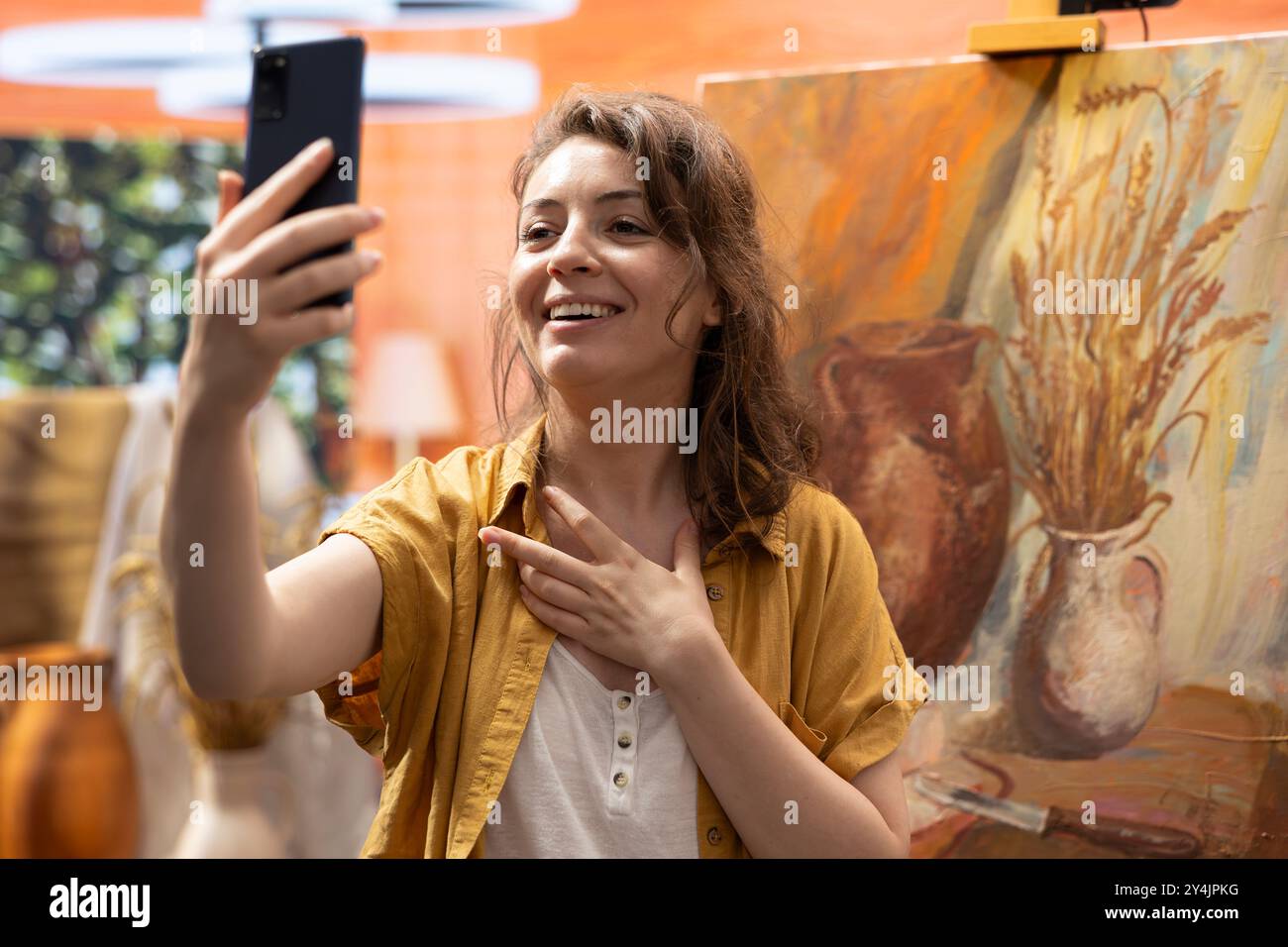 Smiling artist self advertising her skill and painting techniques for ...