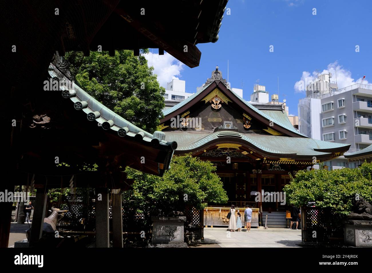 Visitors praying in front of the main hall (Honden) of the historic ...
