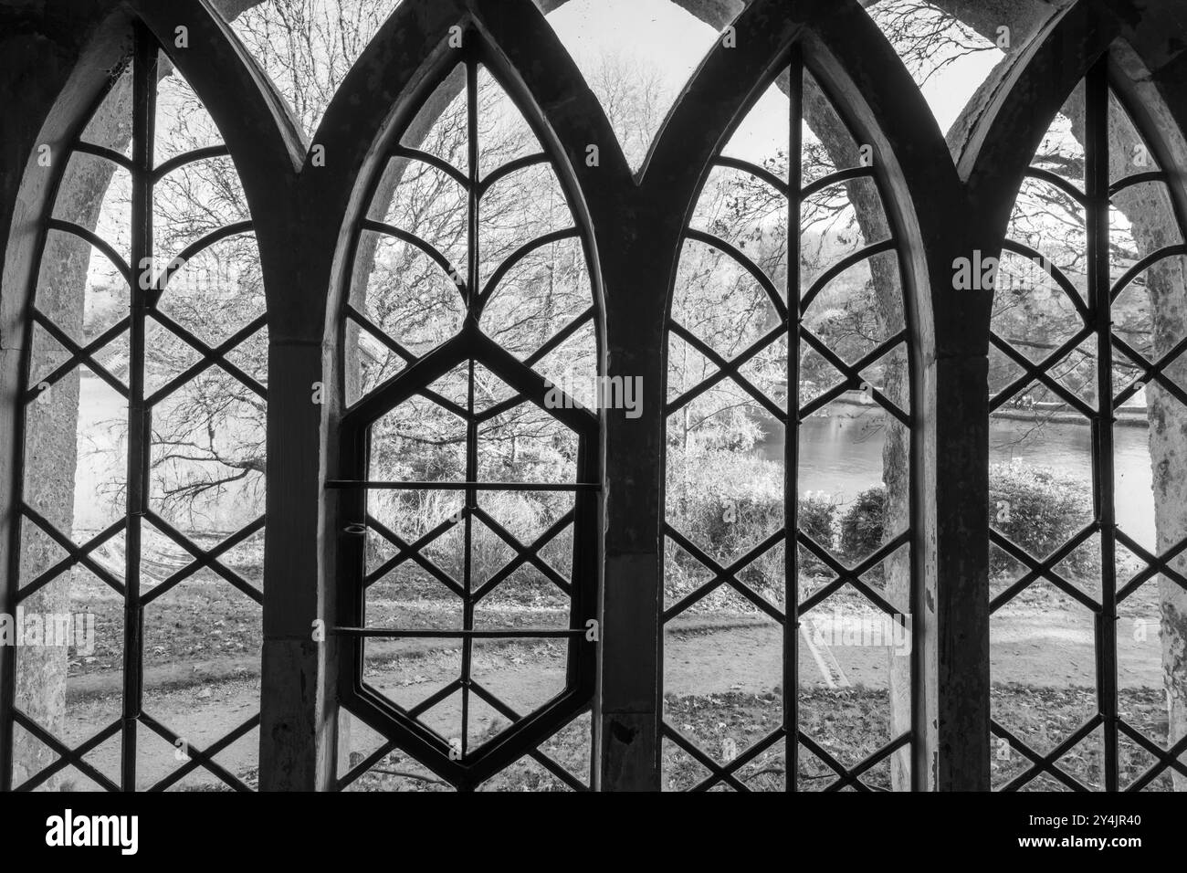 View through the window of the Gothic cottage of the lake at Stourhead ...