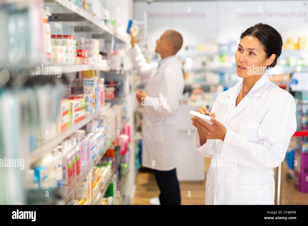 Pharmacist checking medicines in drugstore Stock Photo - Alamy