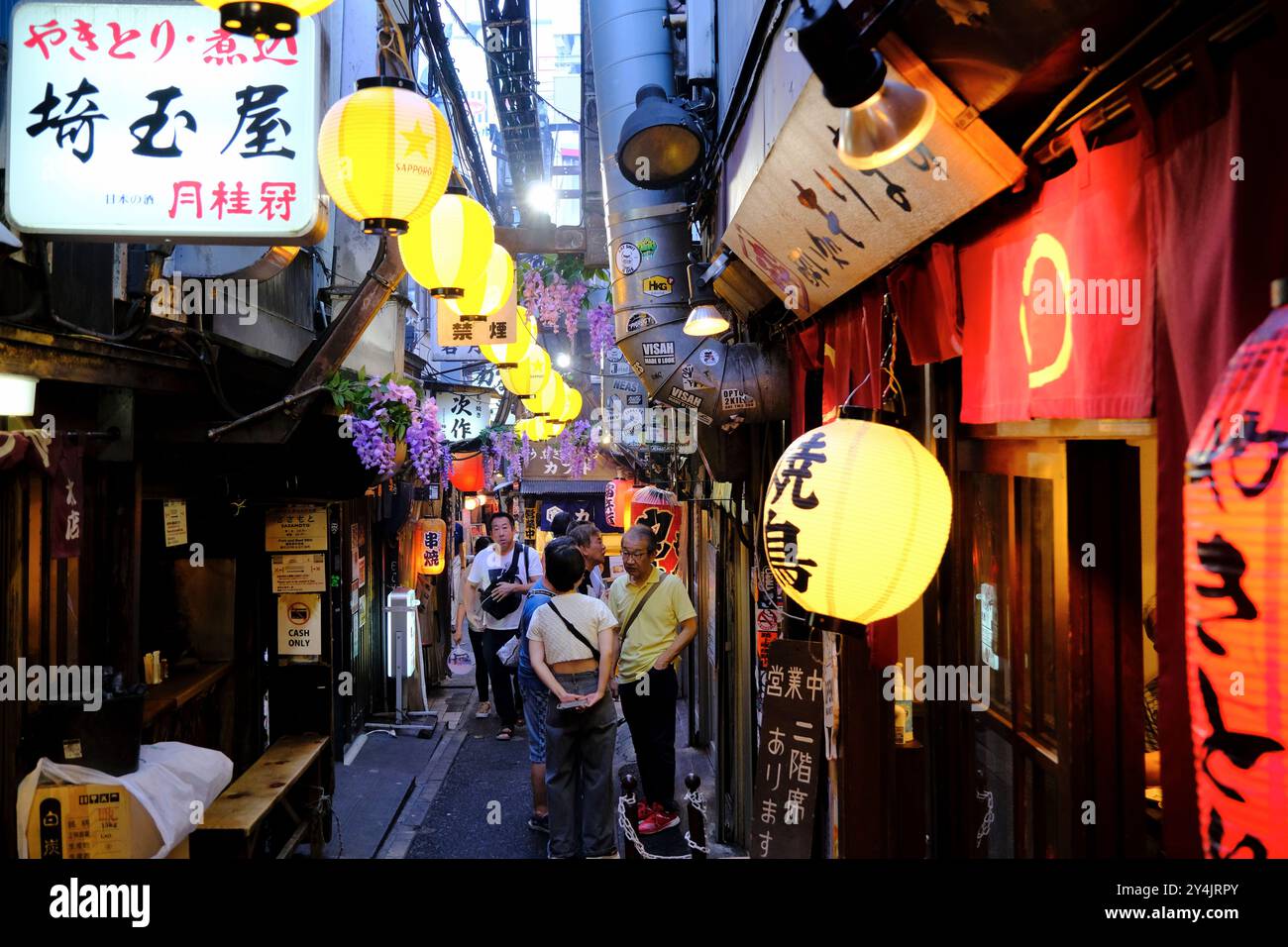 Omoidde Yokocho a nerrow alleyway lined up with Izakaya bars and ...