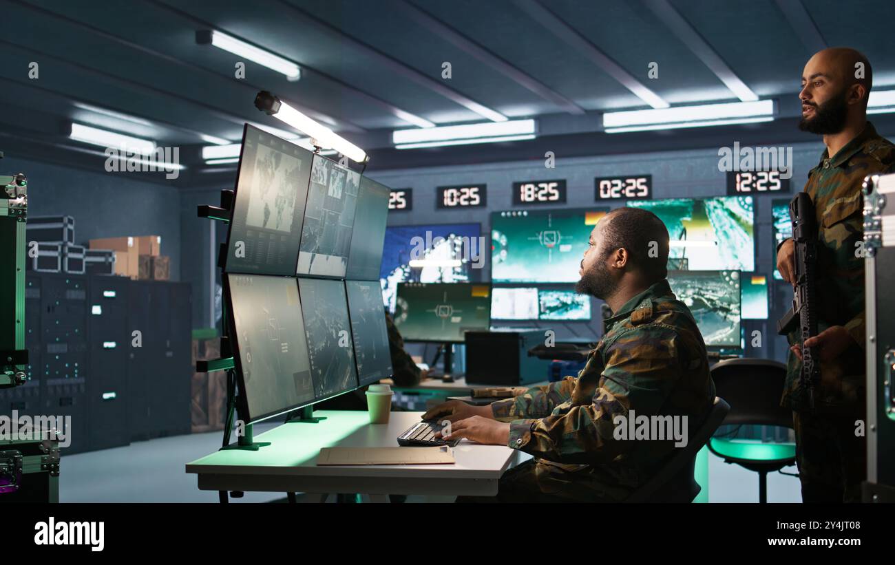 Military agent working in control room, analyzing aerial reconnaissance ...