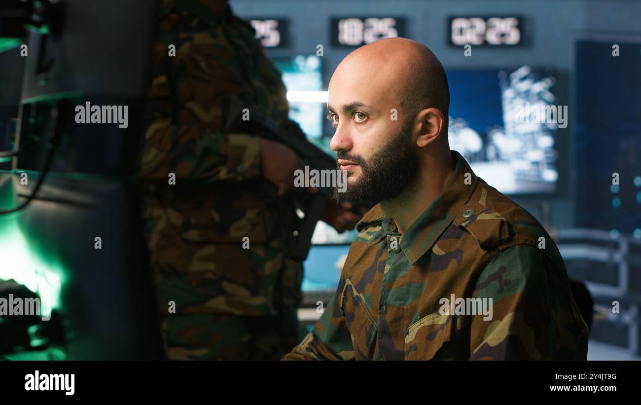 Military officers checking weapons in control room, ensuring bullets and supplies are properly ...