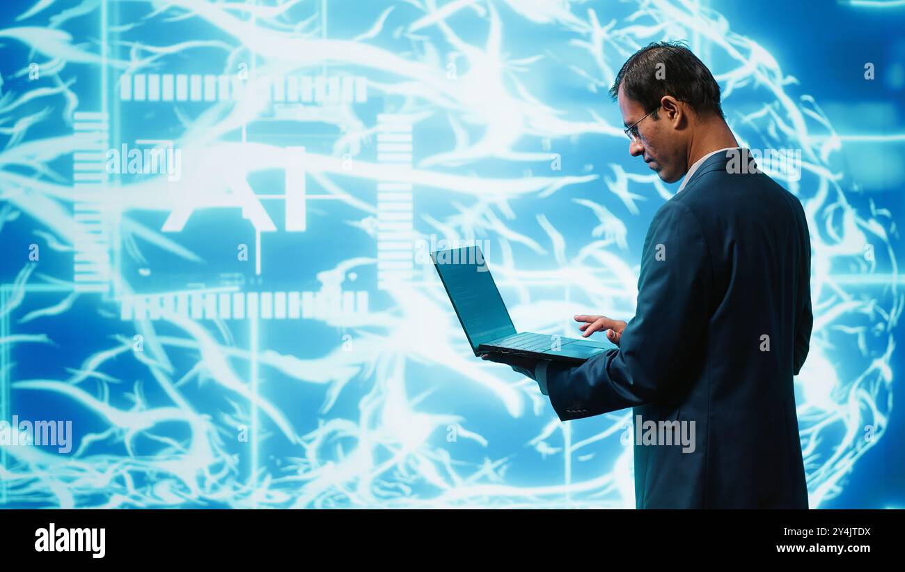 System administrator working on laptop, programming artificial ...