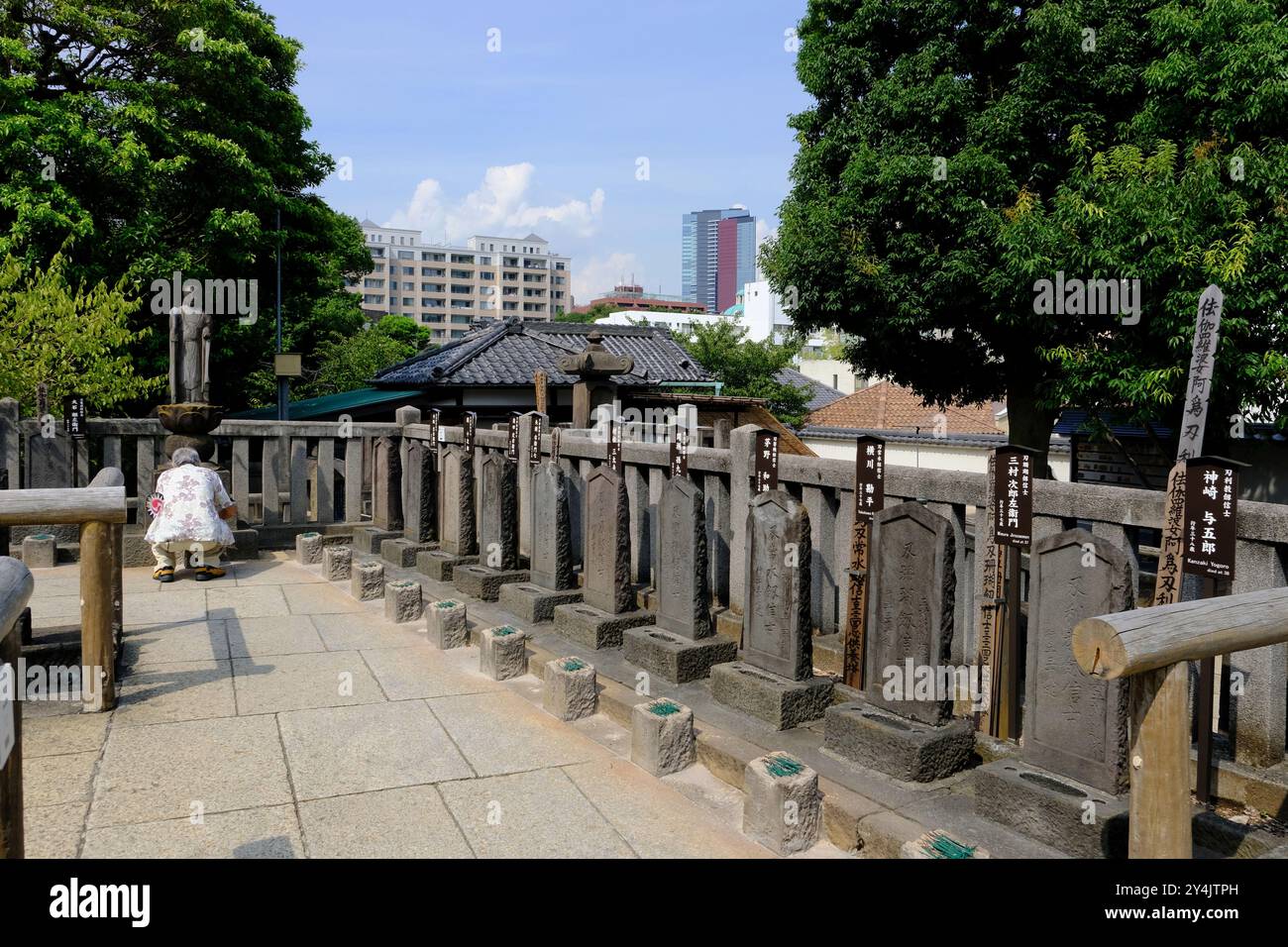 Visitor offering incenses to the graves of the 47 Ronin of Akō incident ...