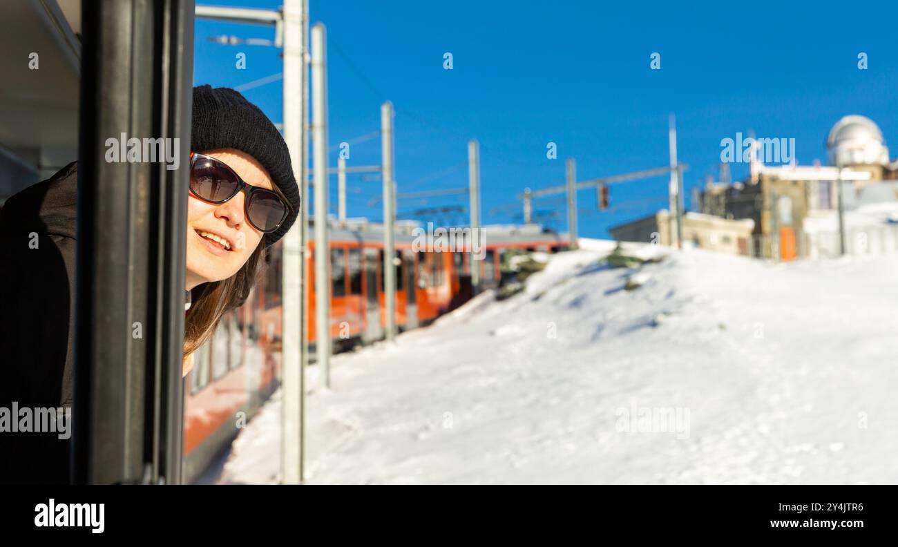 Happy woman in sunglasses sticking head out of train window passing ...