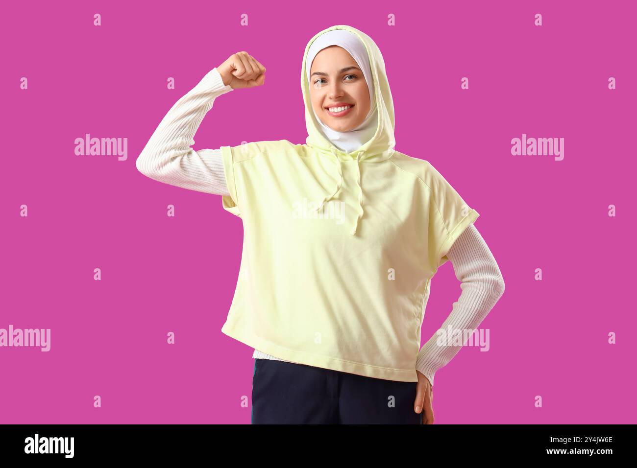 Sporty Muslim woman showing muscles on purple background Stock Photo ...