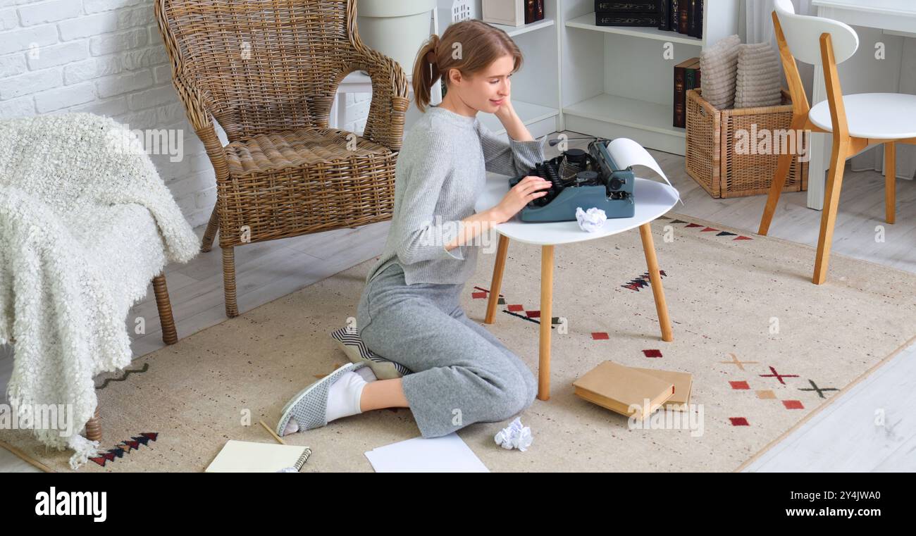 Female author using vintage typewriter at home Stock Photo - Alamy