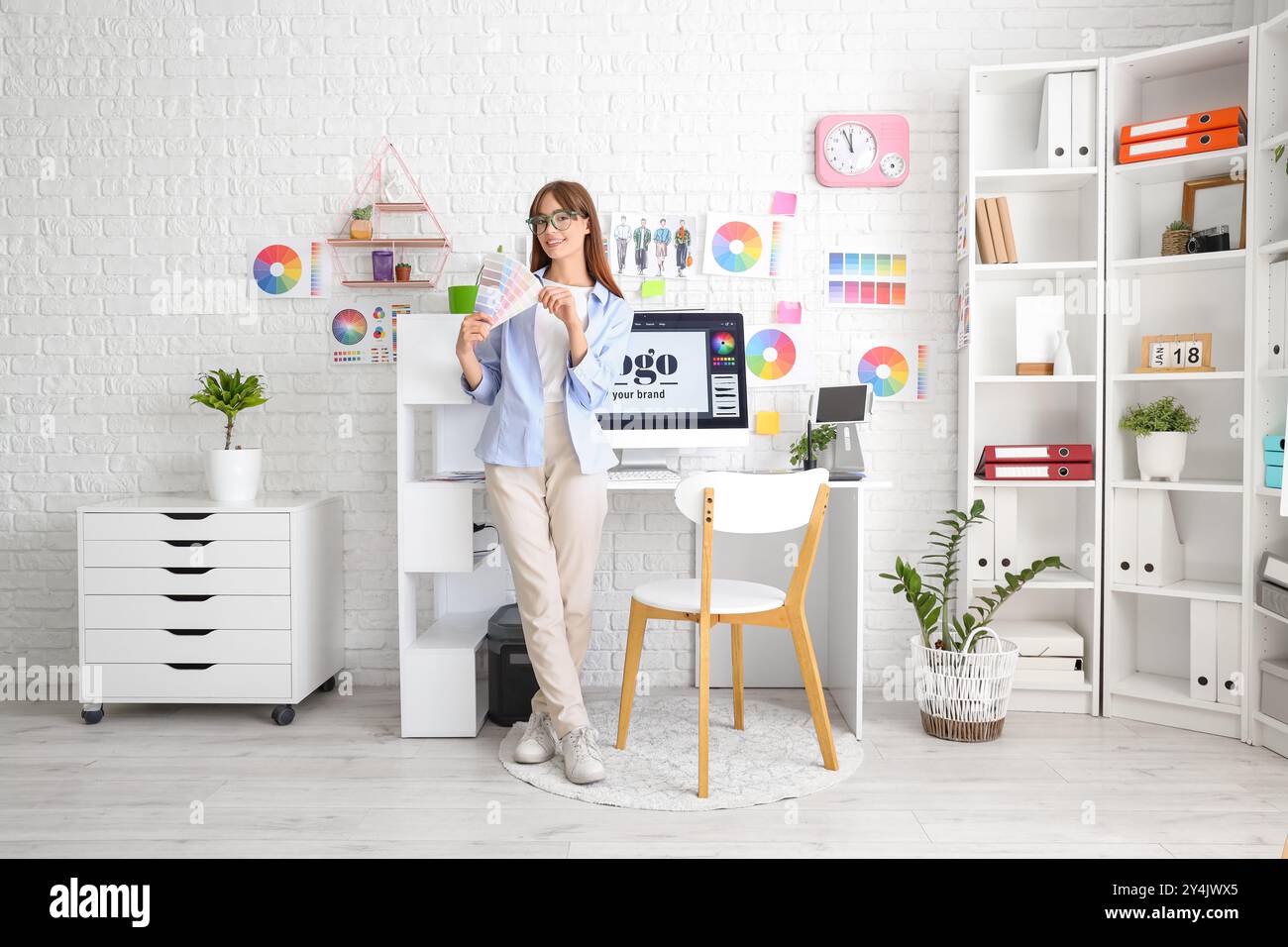 Female graphic designer with color palettes in office Stock Photo - Alamy