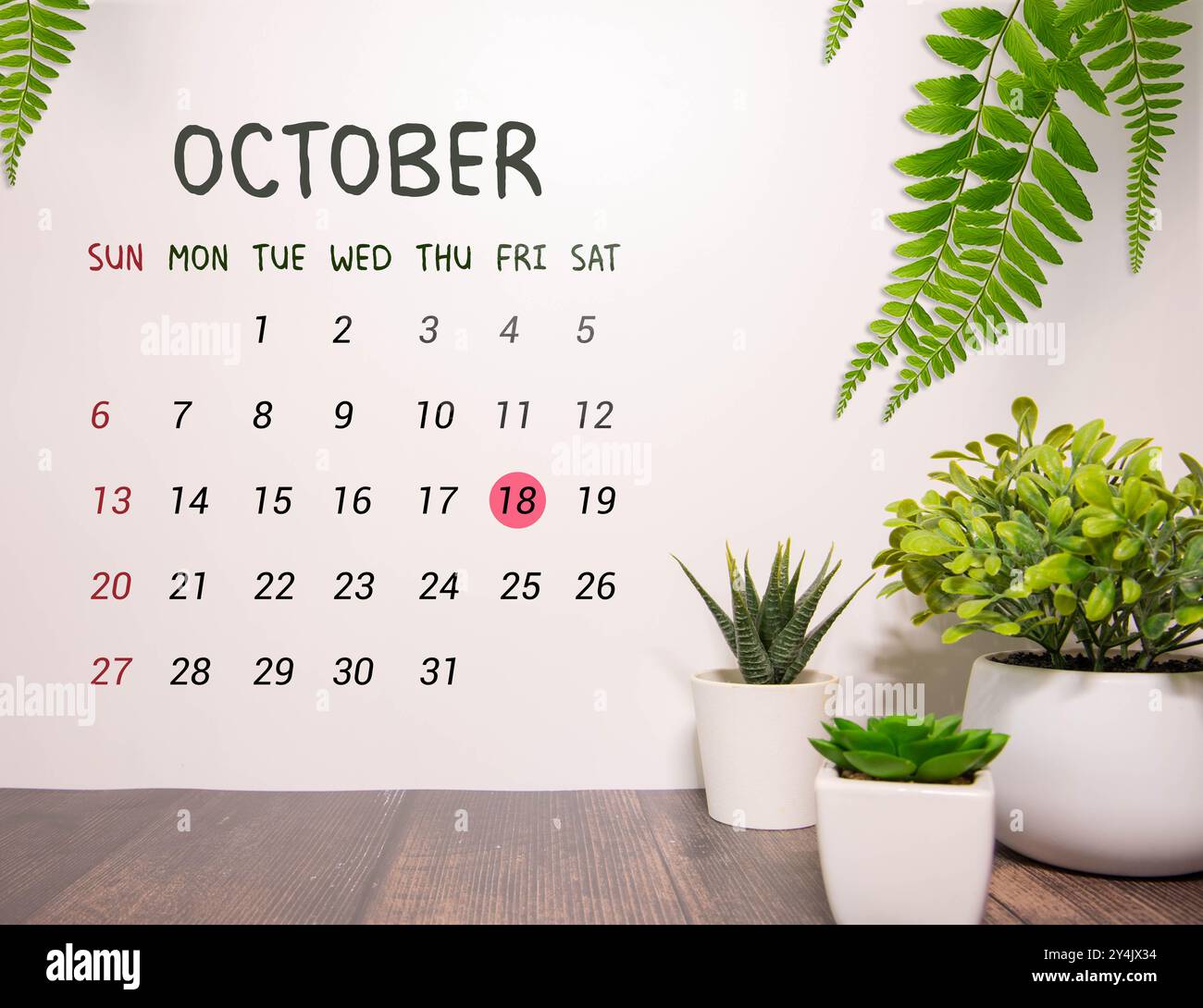 Wooden calendar with the date October 18 on desktop with laptop Stock ...