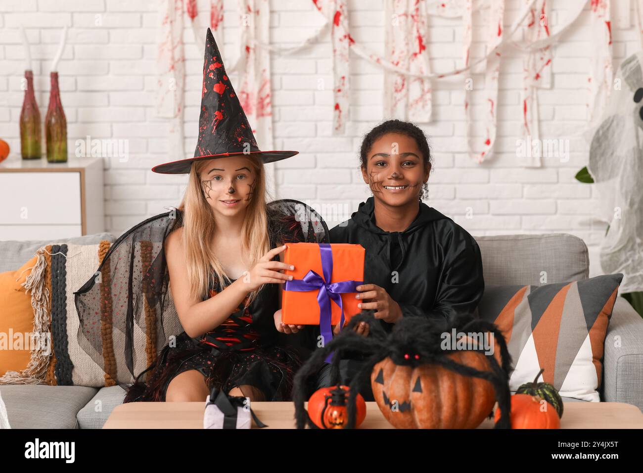 Cute happy girls in different costumes with gift box dressed for ...